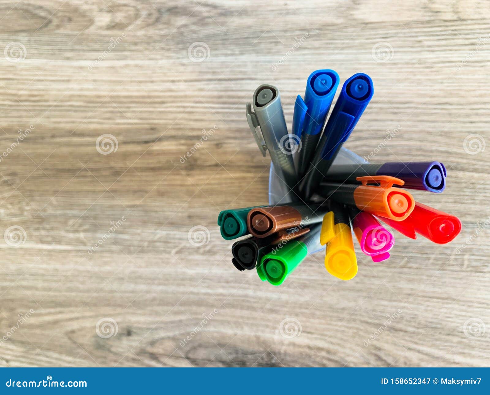 Set of Markers in a Plastic Cup on Wood Table. Stock Image - Image of ...