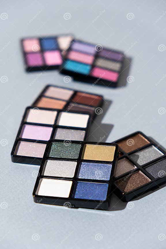 A Set of Multi-colored Eyeshadow on a Blue Background. Eye Makeup Stock ...