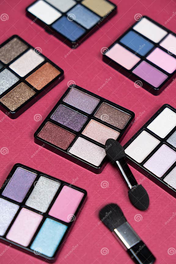 A Set of Multi-colored Eyeshadow and Brushes on a Pink Background. Eye ...