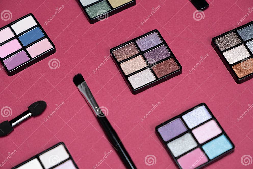 A Set of Multi-colored Eyeshadow and Brushes on a Pink Background. Eye ...