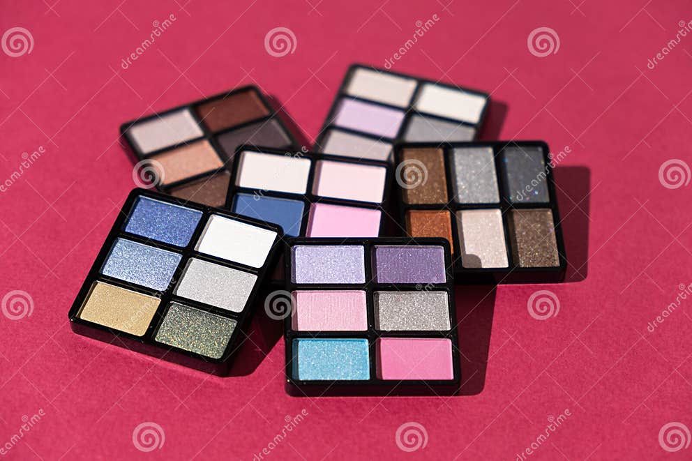 A Set of Multi-colored Eyeshadow on a Pink Background. Eye Makeup Stock ...