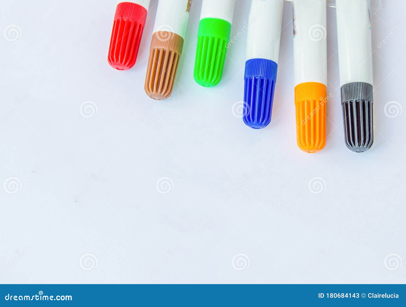 A Set of Multi-colored Markers on the Upper Edge on a White Background ...