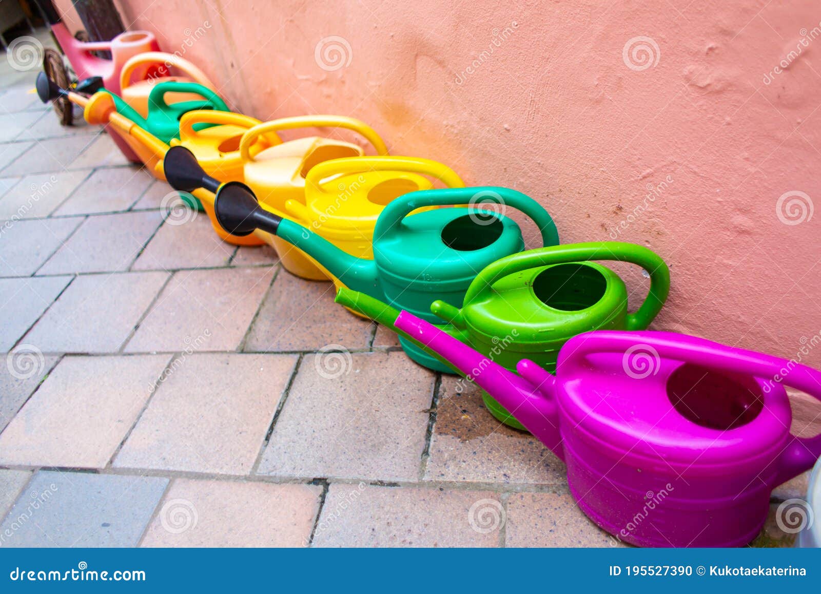 Set of Multi-colored Plastic Watering Cans for Garden Care Stock Photo ...
