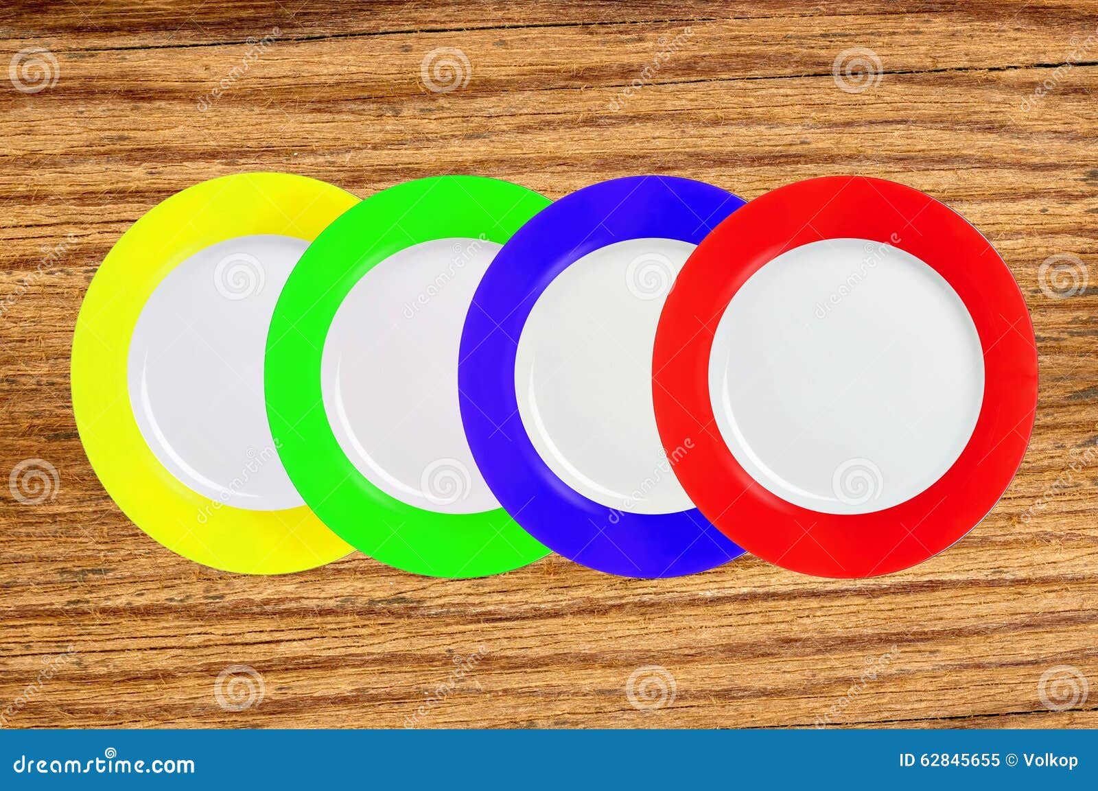 Set of Multi Colored Plates on Wooden Background Stock Image - Image of ...