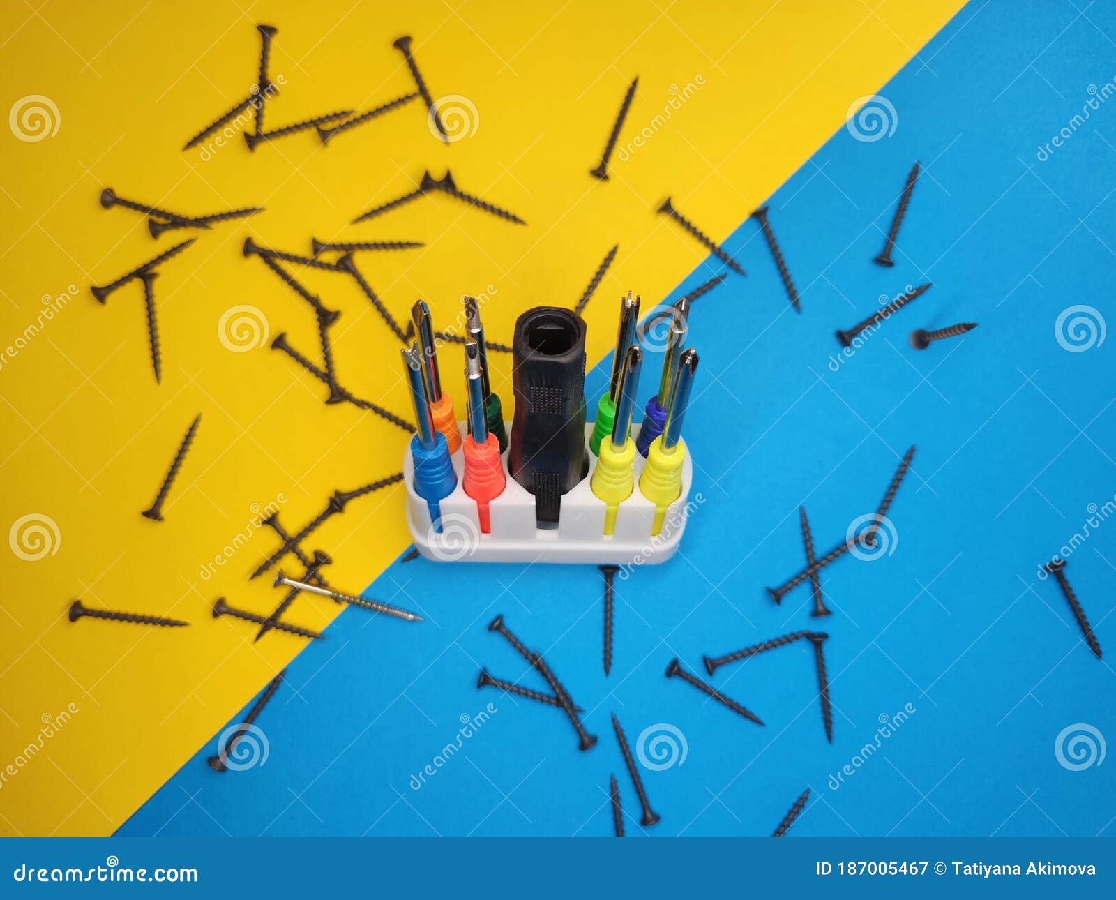 A Set of Multi-colored Screwdrivers in a Case on a Yellow and Blue ...