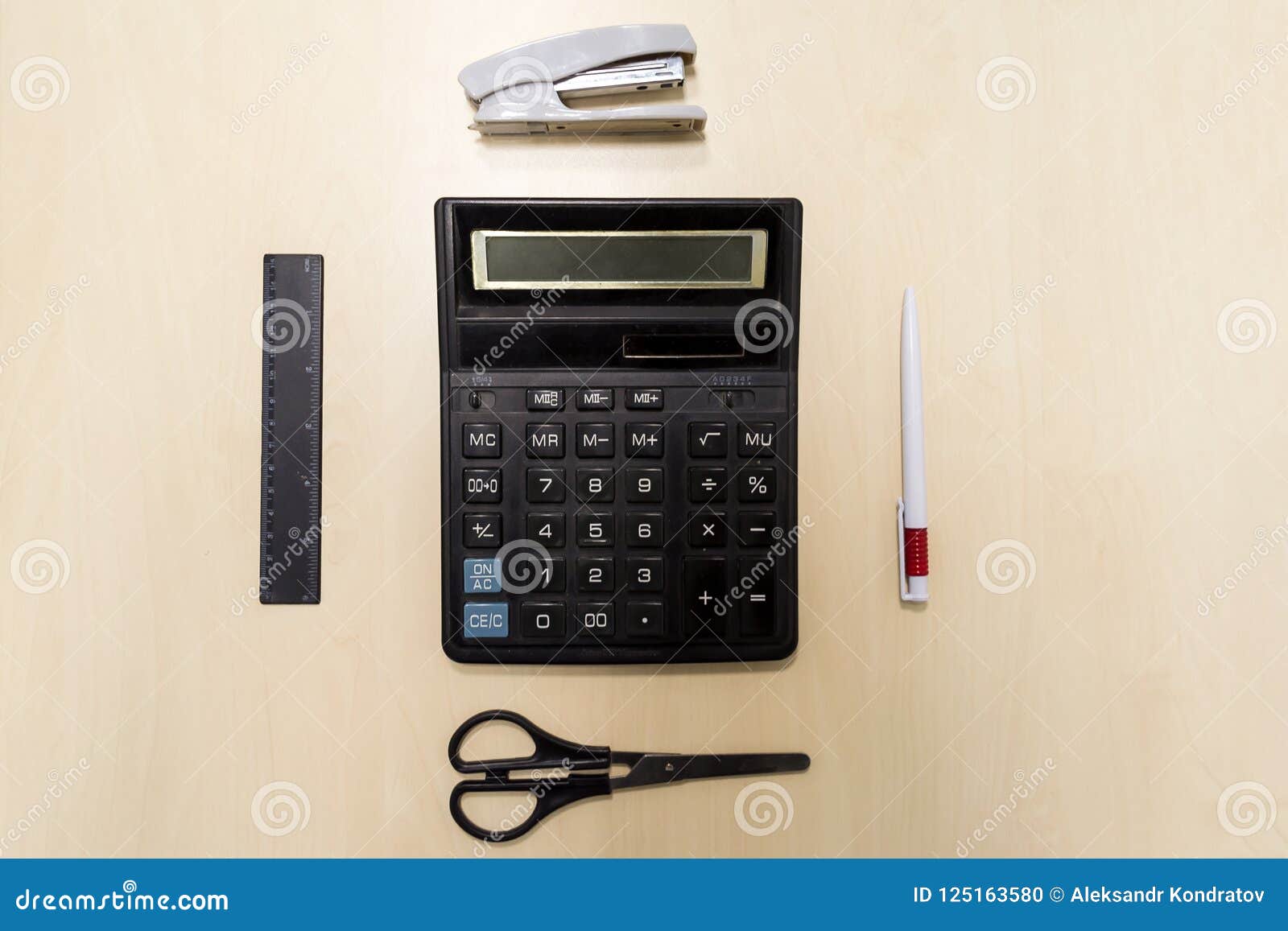 A Set of Office Tools Consisting of a Calculator, Pen, Stapler, Stock ...