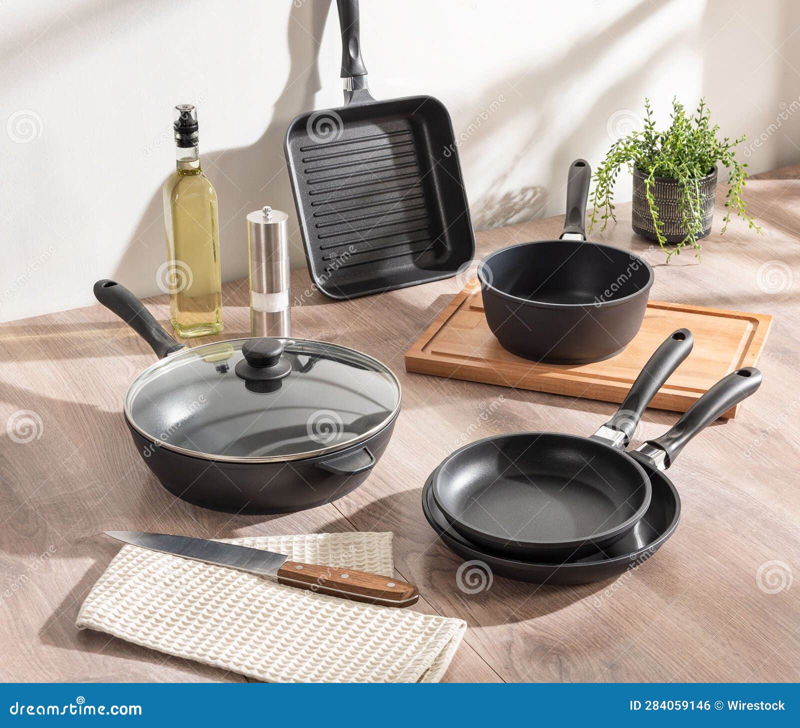 Set of Pans on the Wooden Table. Kitchen Cookware Stock Photo - Image ...