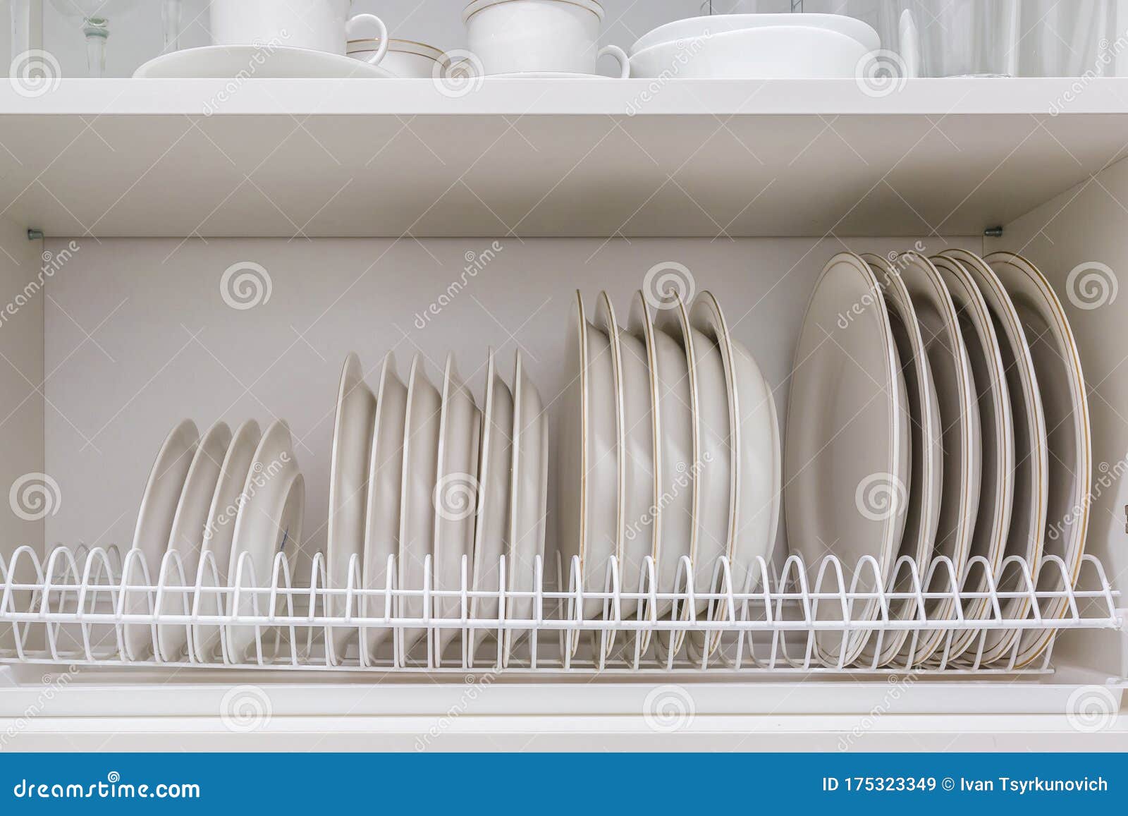 Set of Plates on the Shelf in the Kitchen Cabinet Stock Image - Image ...
