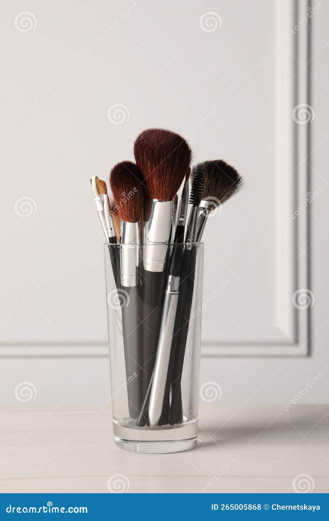 Set of Professional Makeup Brushes on Table Against White Background ...