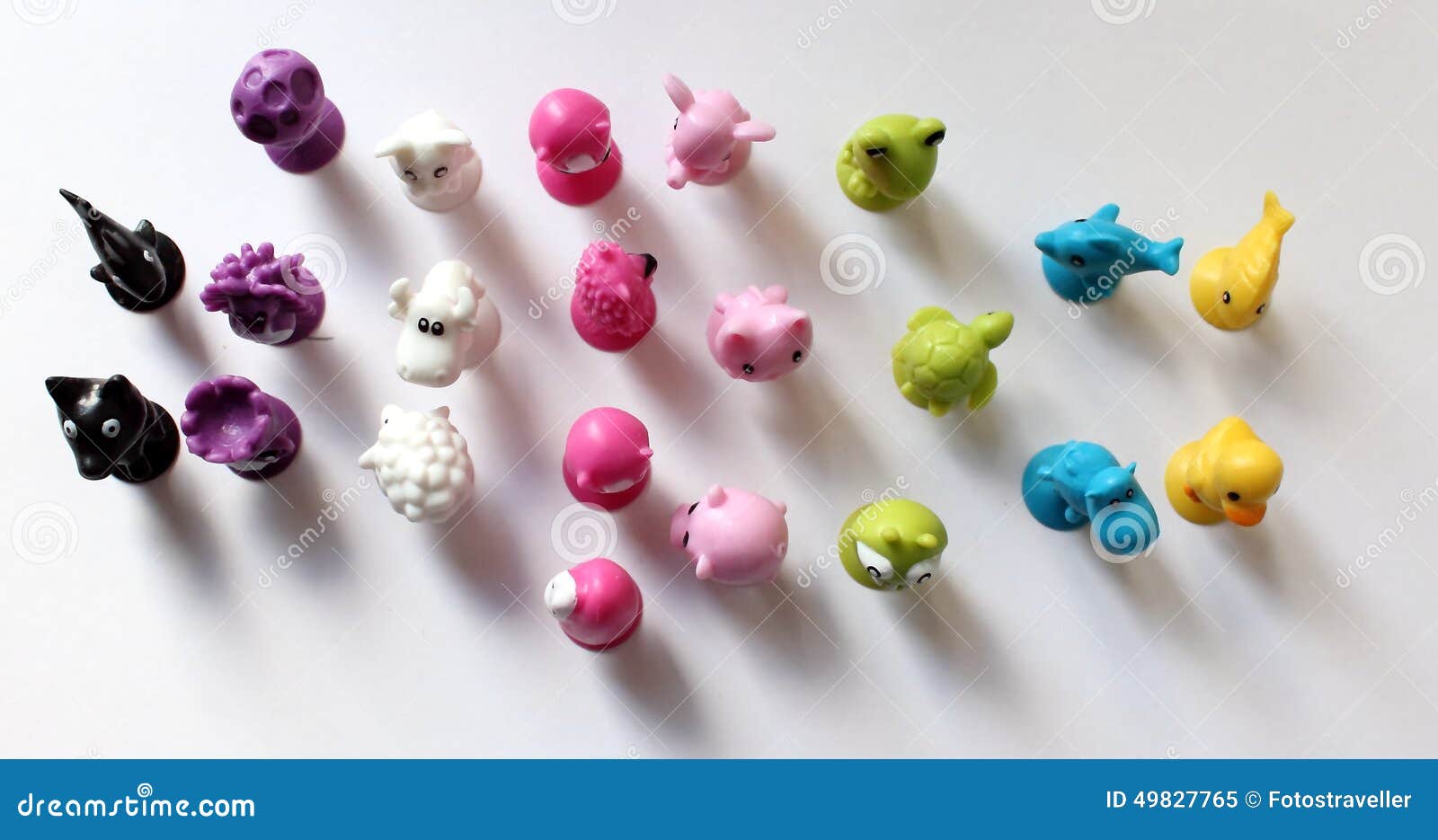 Rubber Toys On Blue And White Background. A Pink Rubber Cat And A ...