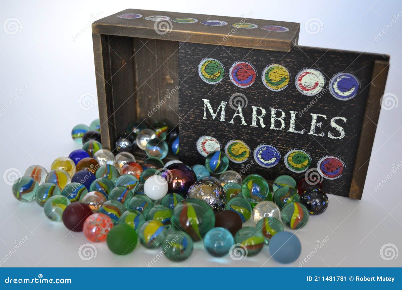 A Set of Shiny Marbles Falling Out of a Box Stock Image - Image of ...