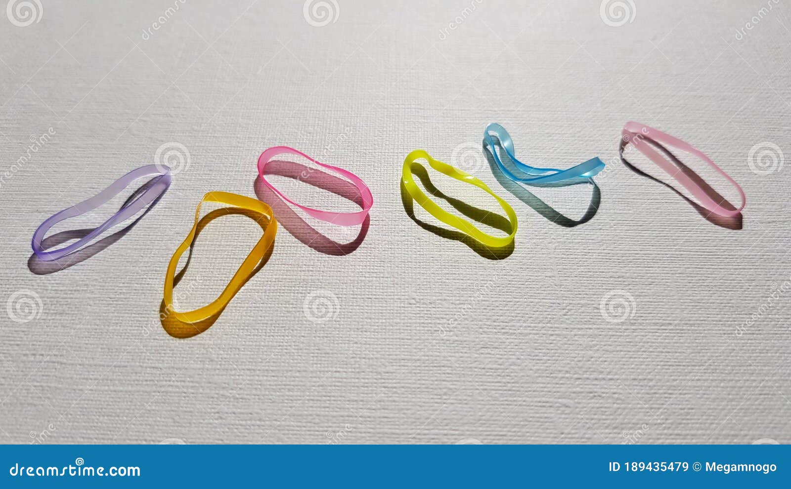 Set of Small Multi-colored Elastic Bands for Hair on a White Table ...