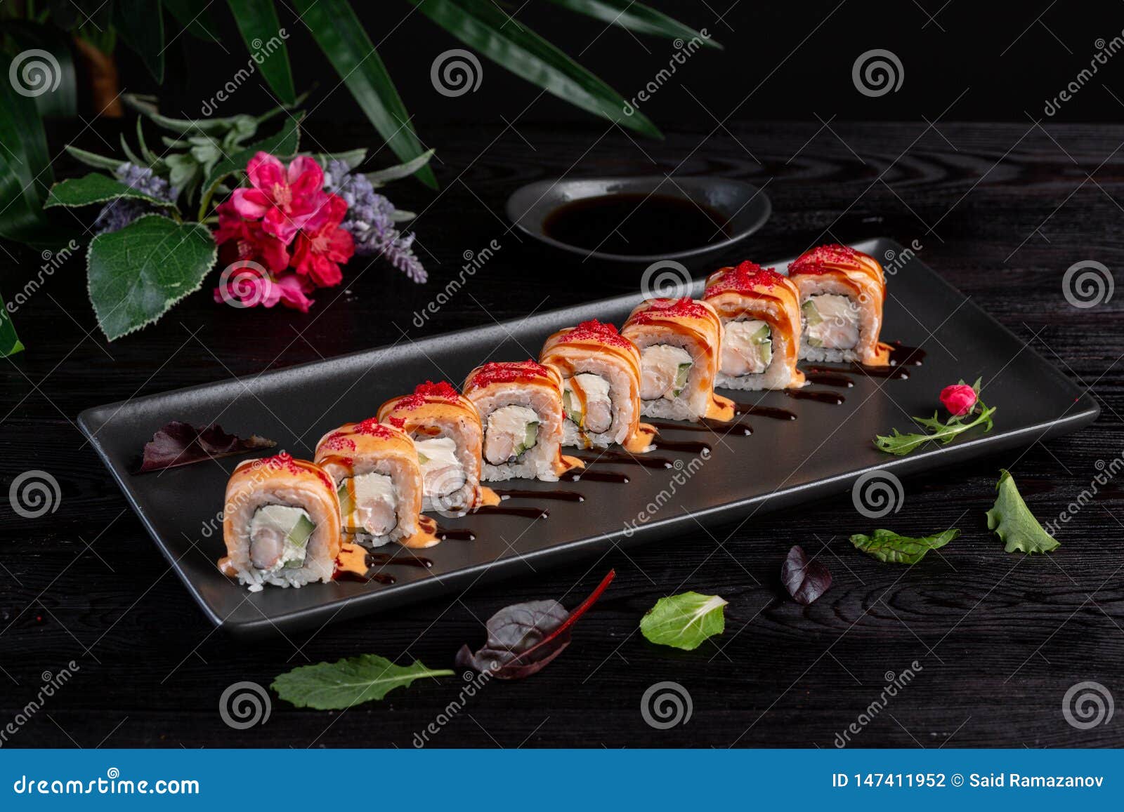 Set Sushi Rolls on a Black Rectangular Plate on a Dark Background Stock ...
