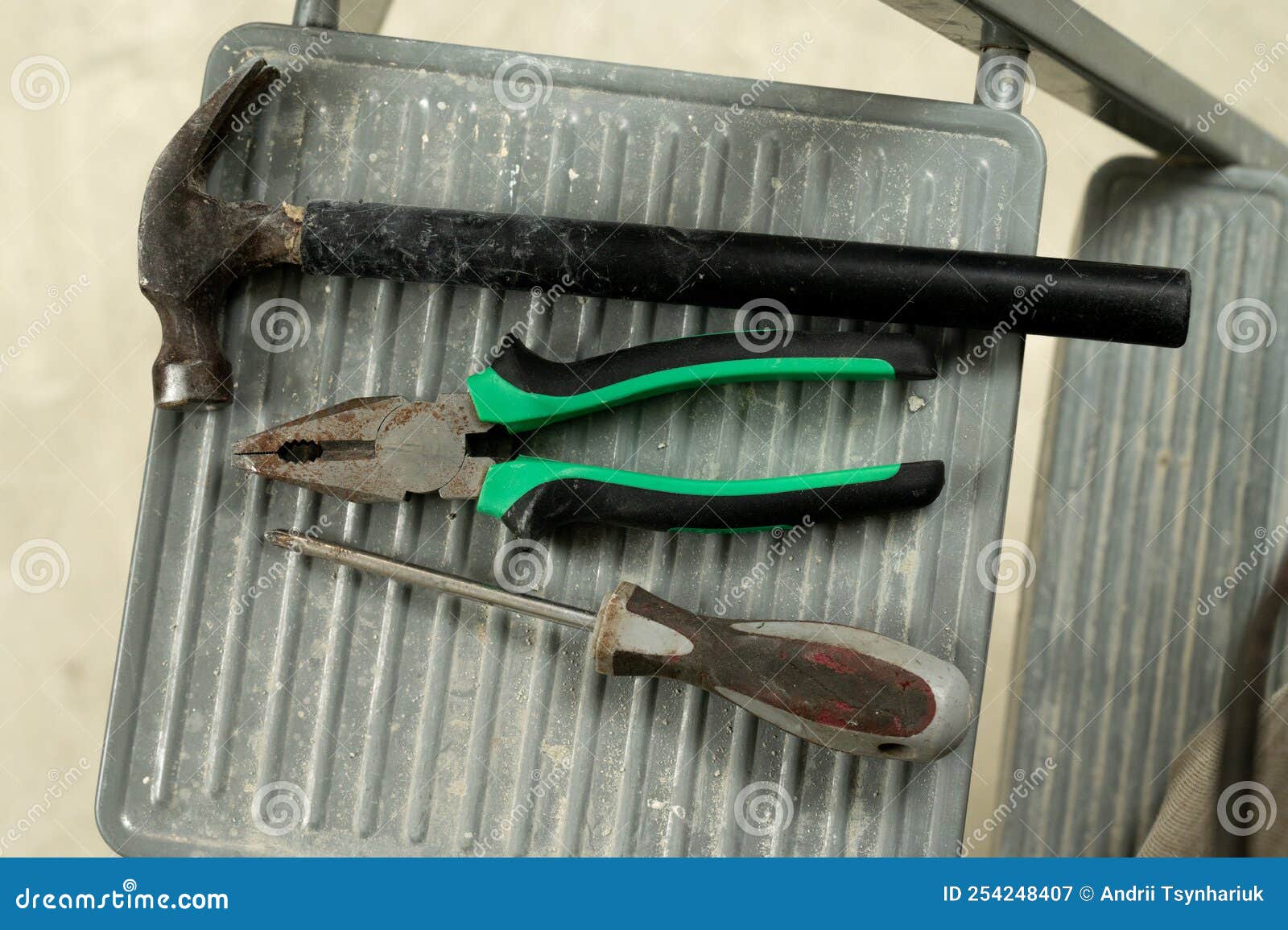 Set of Three Construction Tools on a Ladder Hammer, Pliers and ...