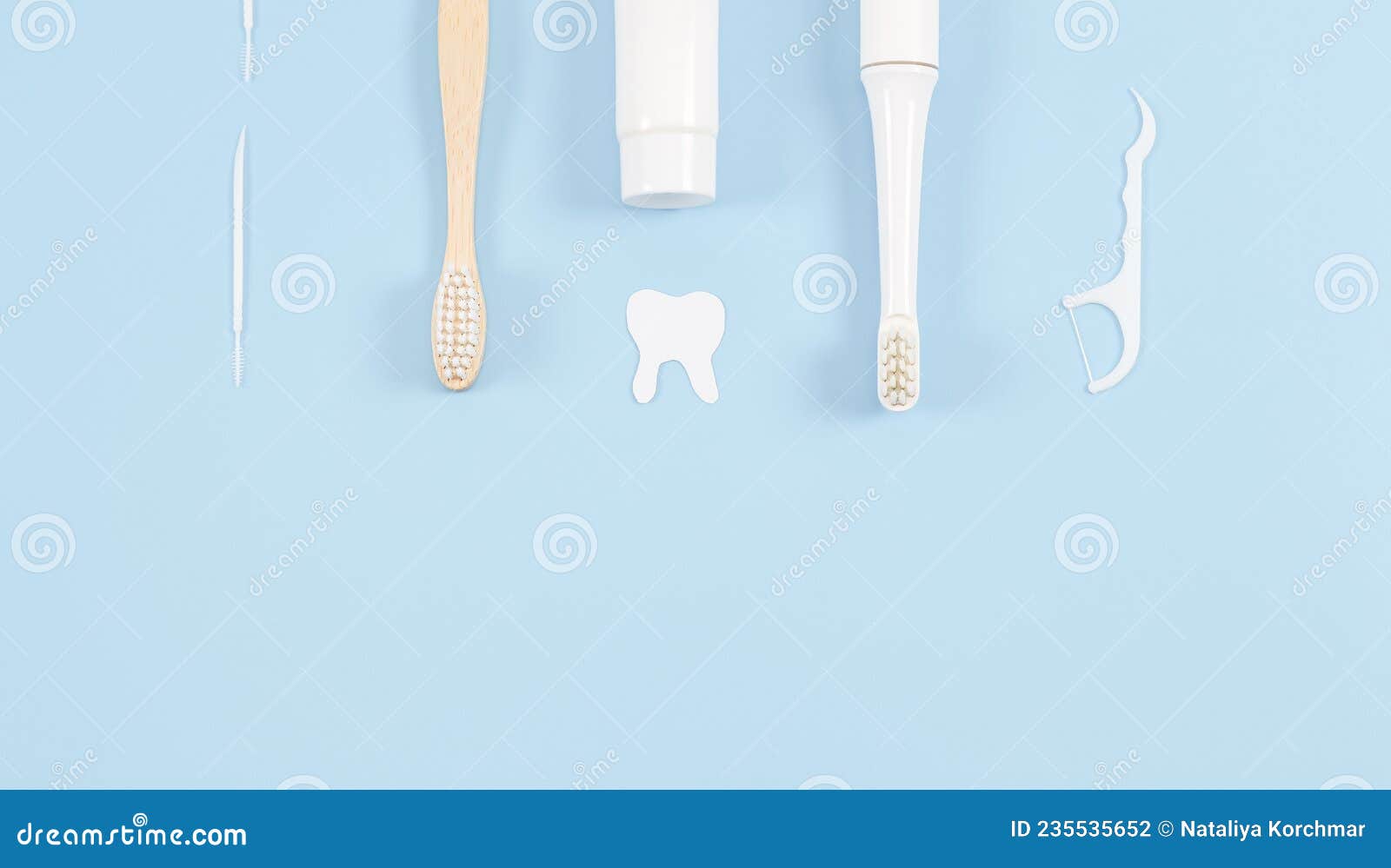 A Set of Toothbrushes, Toothpicks, Dental Floss and Toothpaste on Pale ...