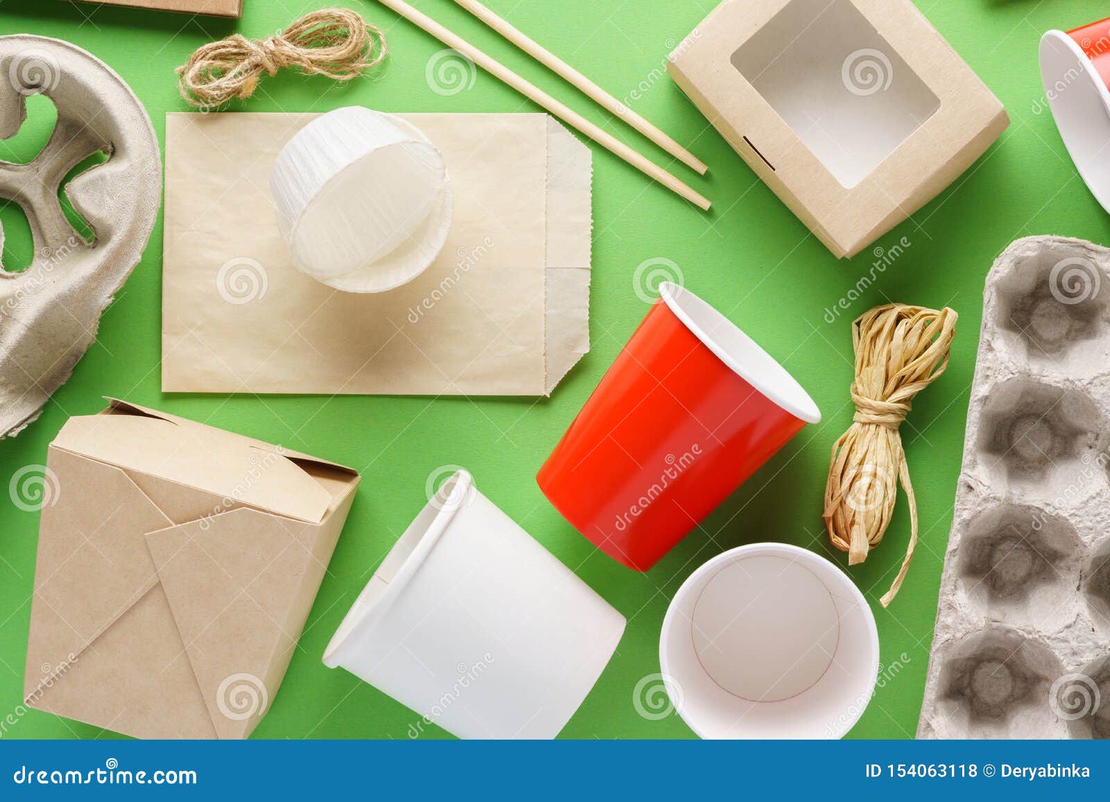 Various Eco-friendly Packaging, Containers on Green Background Stock ...