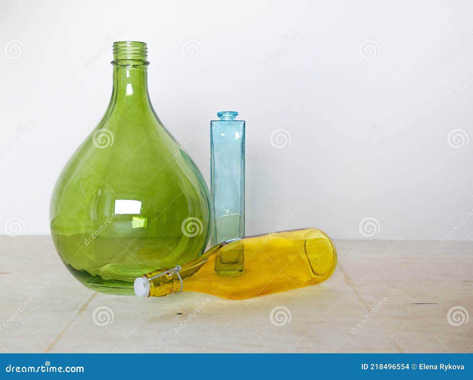Set of Various Muted Colored Glass Bottles Against White Wall Stock ...