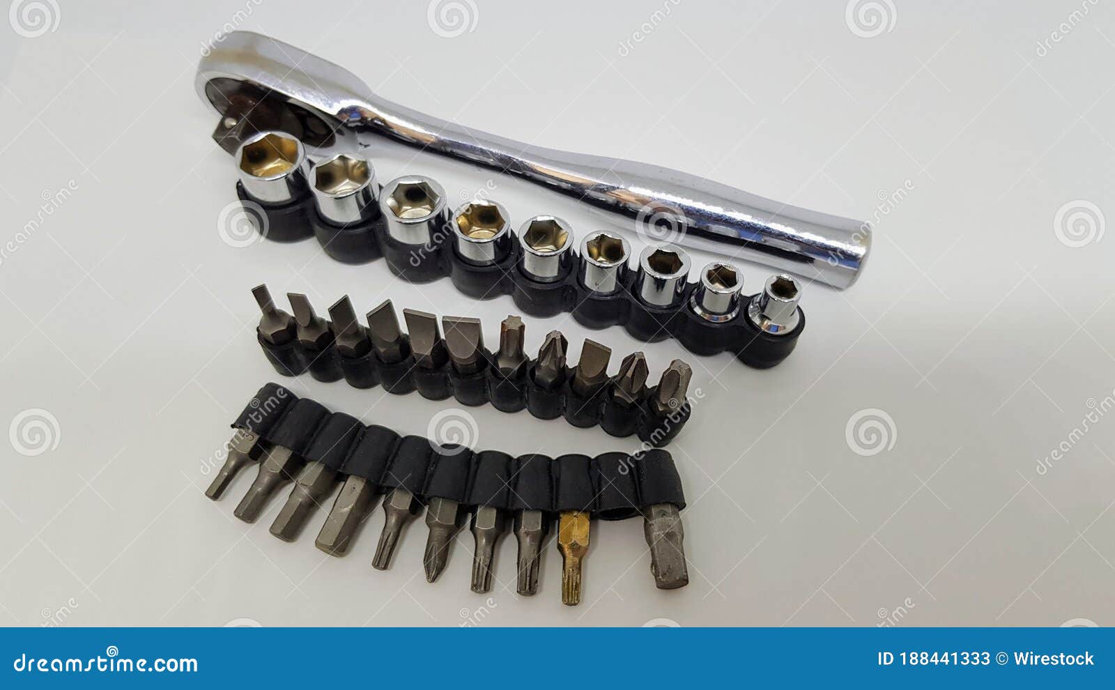 Sets of Screwdriver Adapters with Rubber Holders Behind a Metal Object ...