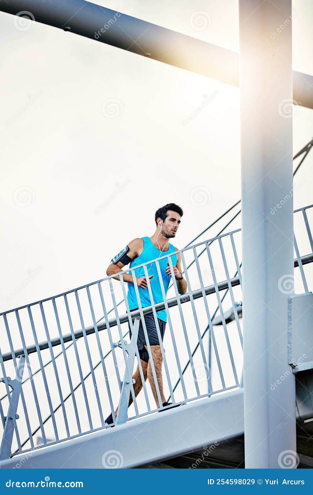 Setting a Good Pace. Low Angle Shot of a Handsome Young Man Working Out ...