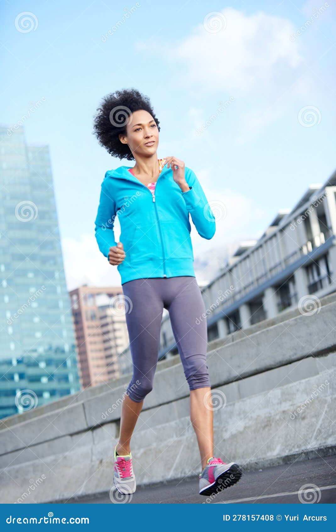 Setting Her Own Pace. a Young Woman Jogging through the City. Stock ...