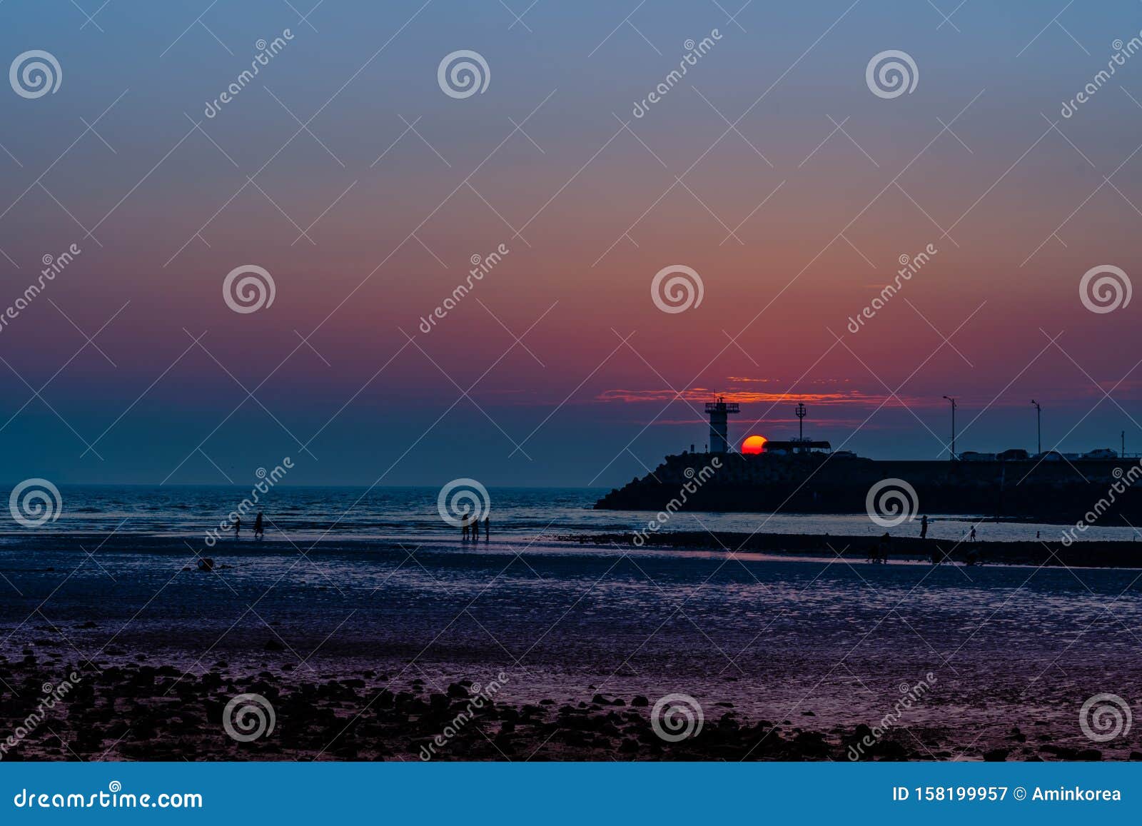 Setting Sun Behind Lighthouse Stock Image - Image of landscape, clouds ...