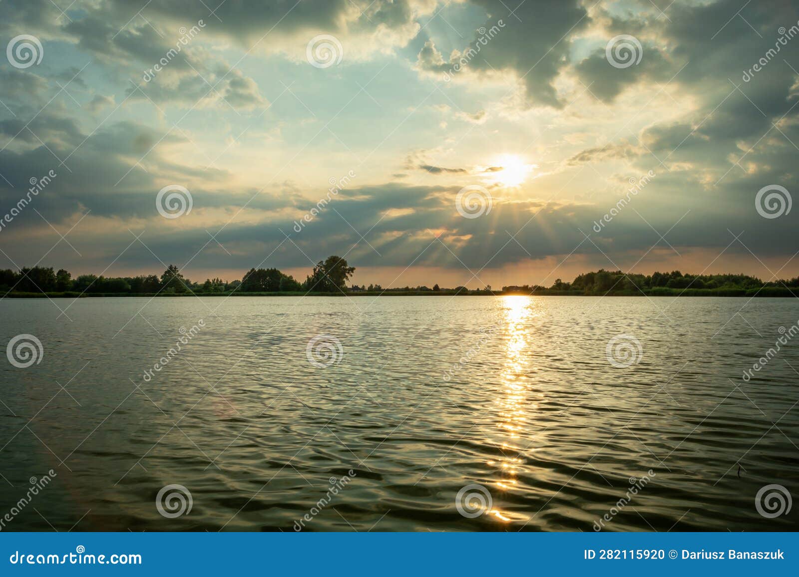 The Setting Sun in the Clouds Over the Lake Stock Photo - Image of ...