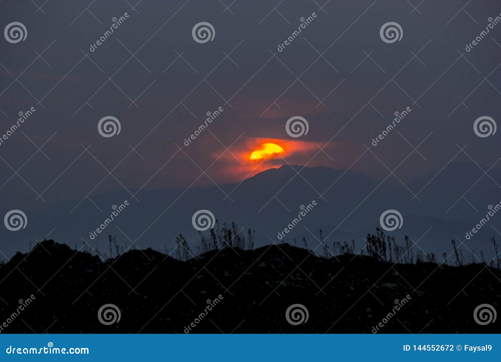 Setting Sun with Haze and Clouds and Mountain Stock Photo - Image of ...