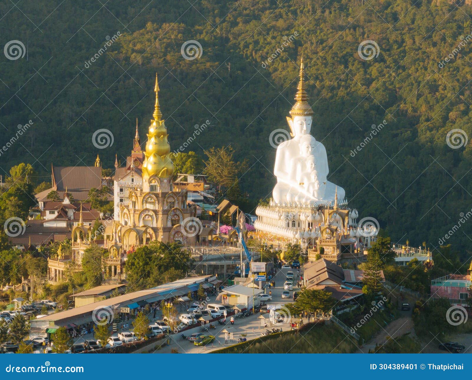 The Setting Sun Illuminates a Striking White Buddha Statue beside an ...