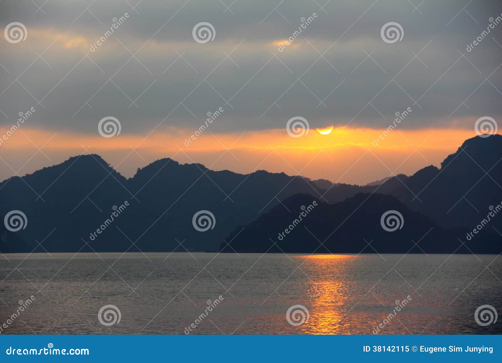 Setting Sun Peeking Out from the Clouds in Ha Long Bay, Landscape View ...