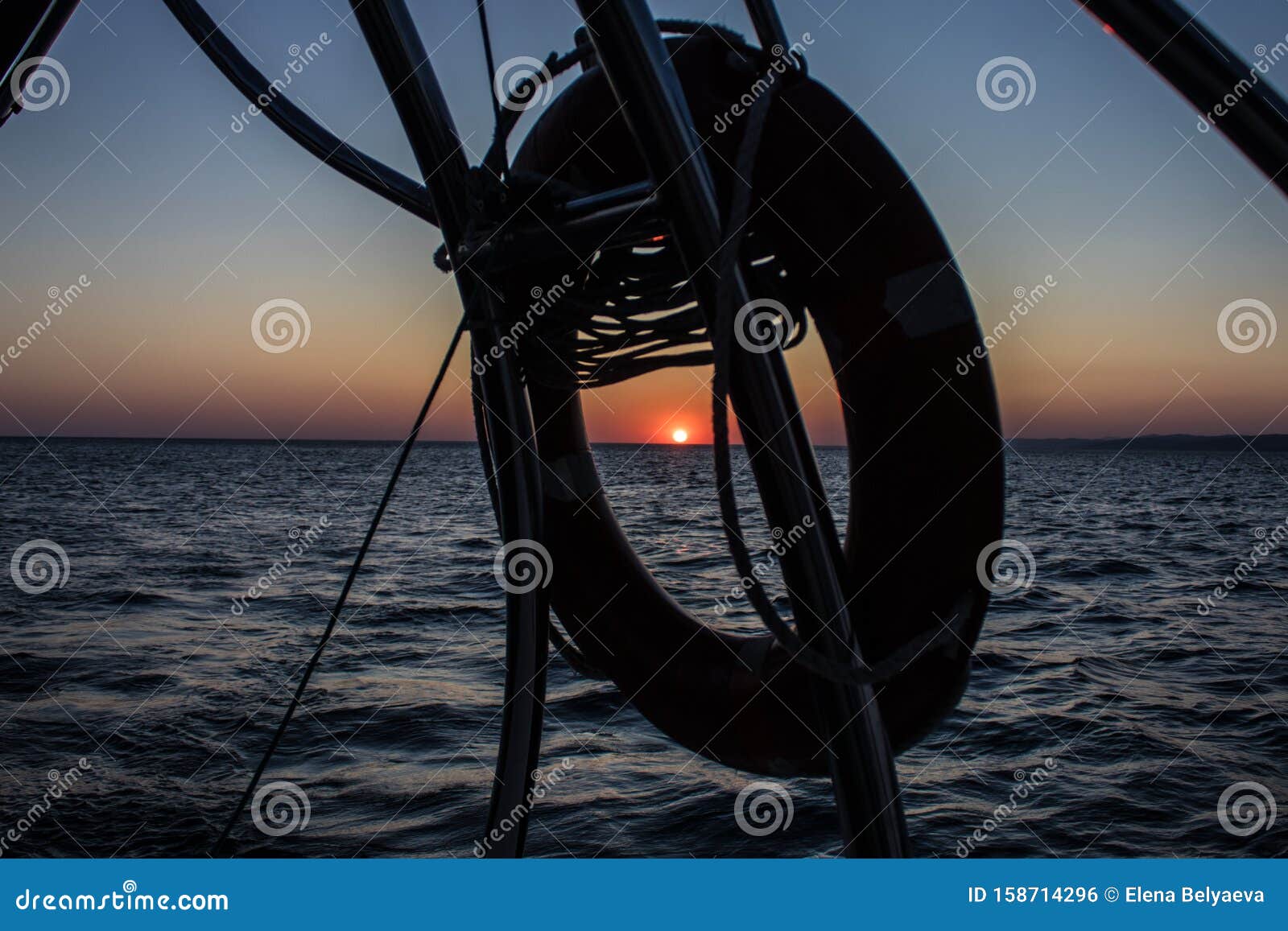 The Setting Sun is Seen through the Lifeline on the Ship Stock Photo ...