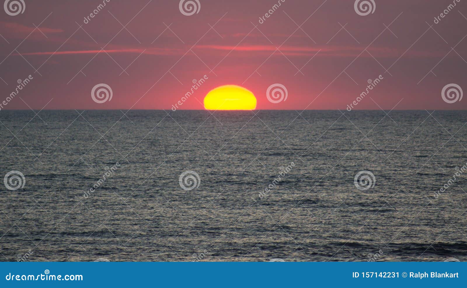 The Setting Sun Touches the Red Horizon. Stock Image - Image of ...