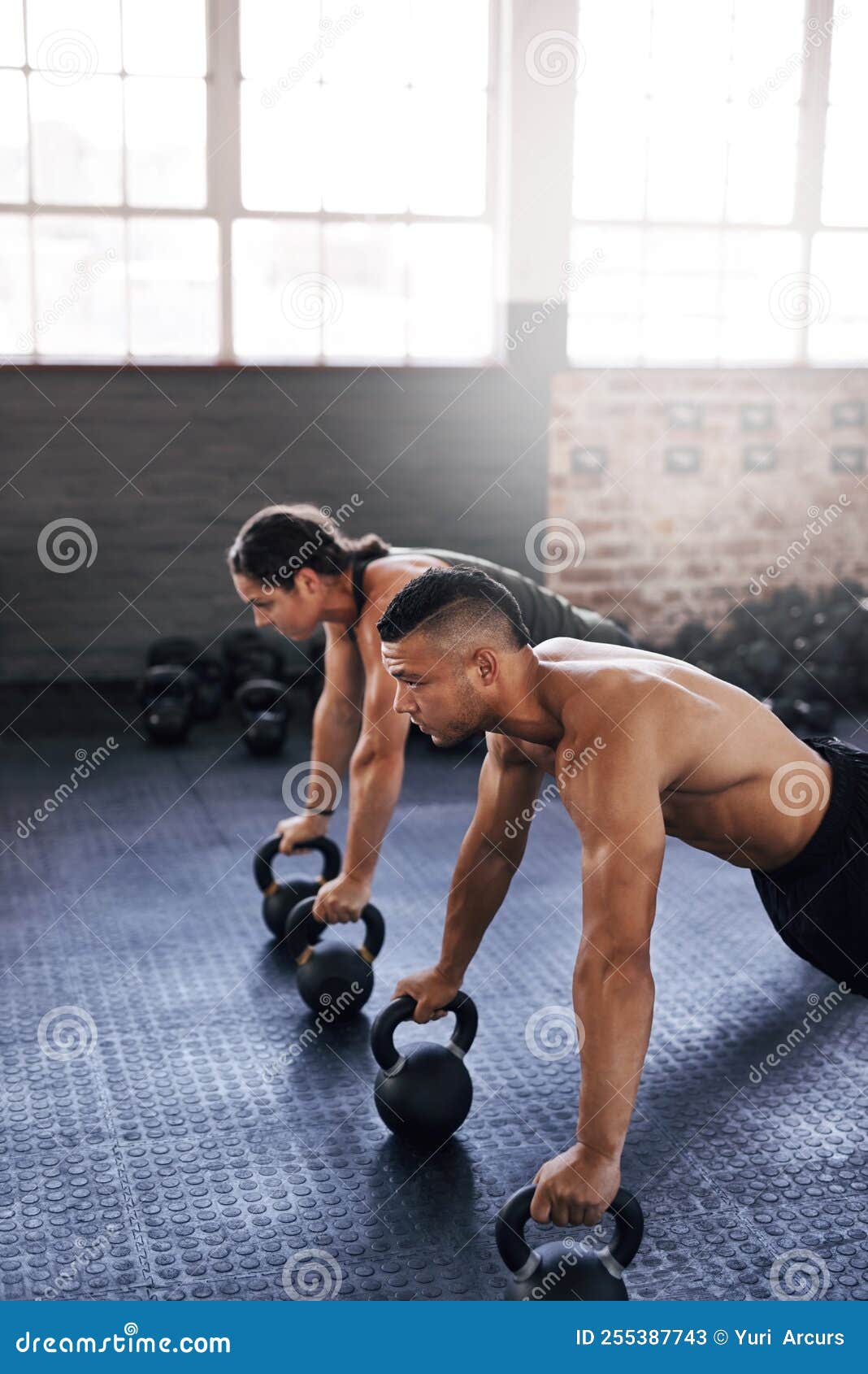 Setting Up for Another Set. Two Young Athletes Working Out in the Gym ...
