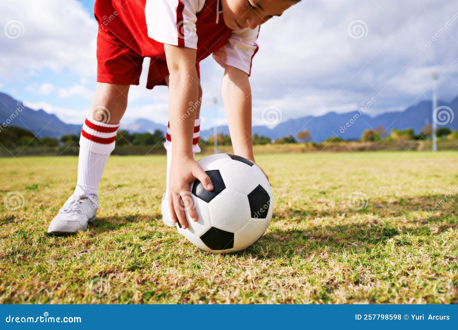 Setting Up the Freekick. a Kid Setting Up a Freekick on a Soccer Field ...