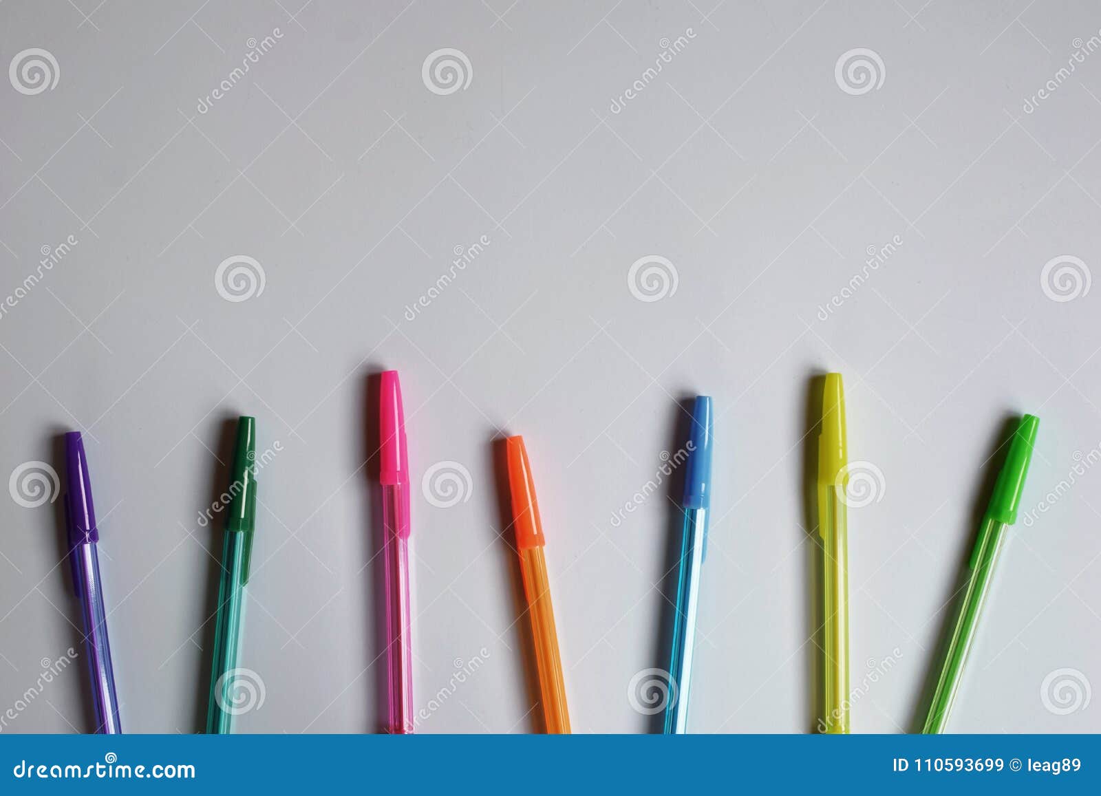 Seven Colored Drawing Pens on Light Blue Table Background Stock Image ...