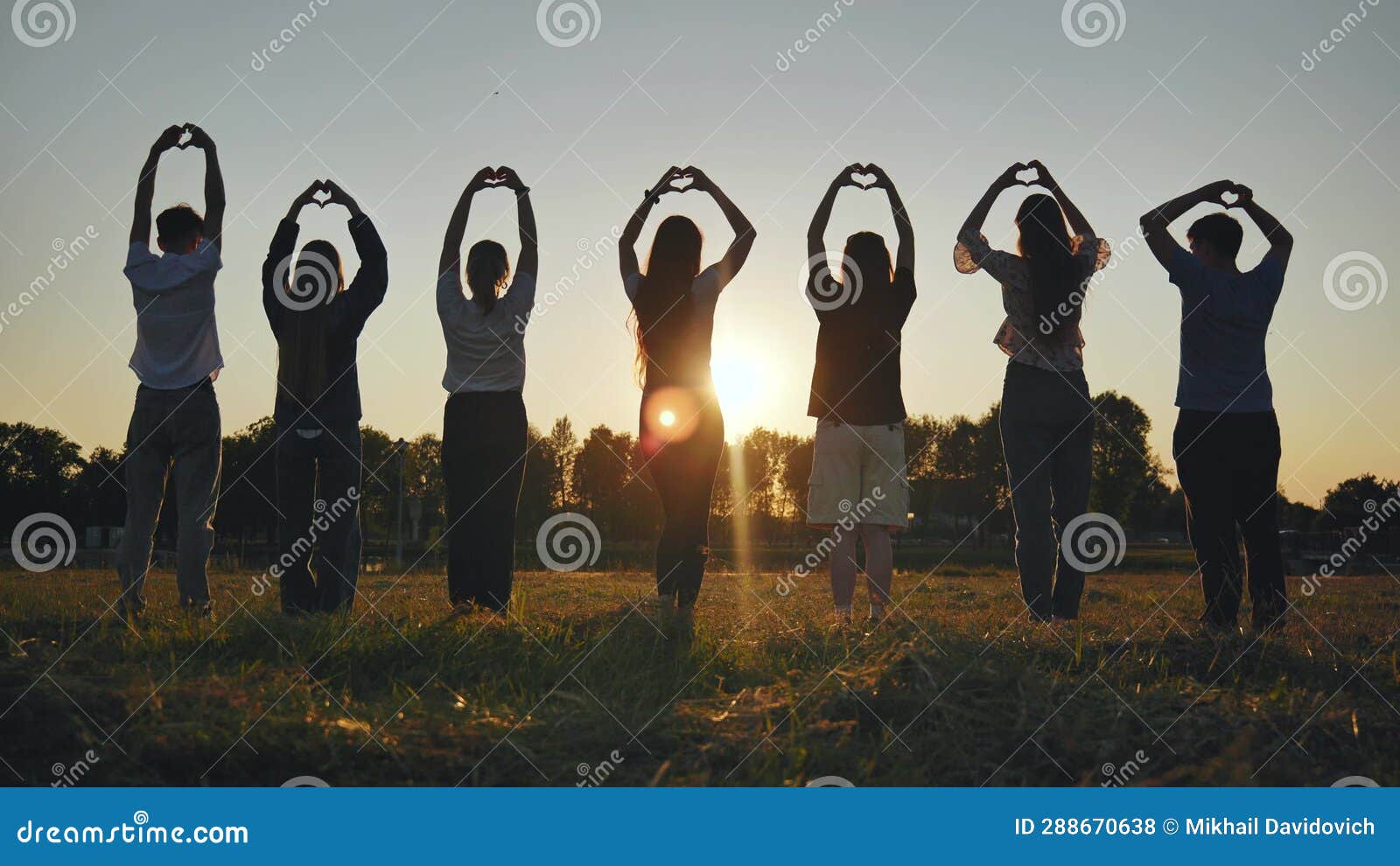 Seven Friends Make a Heart Shape from Their Hands at Sunset. Stock ...