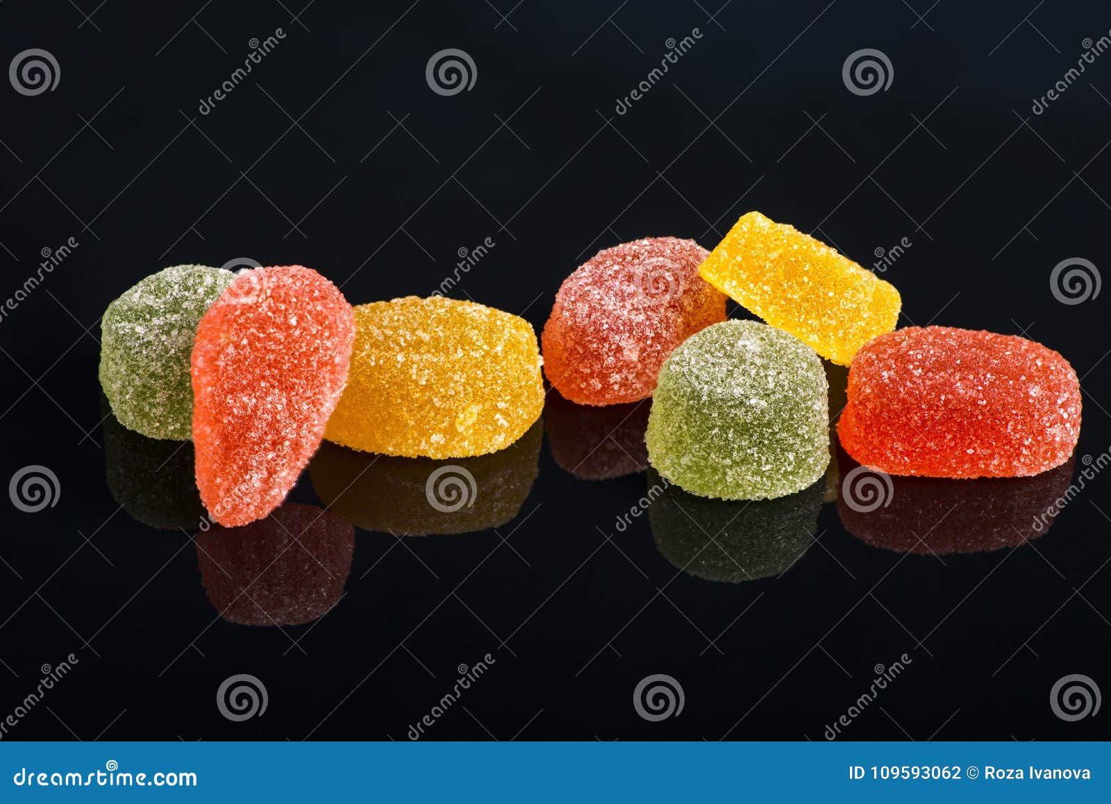 Seven Multi-colored Fruit-paste Sweets on the Black Reflecting Stock ...