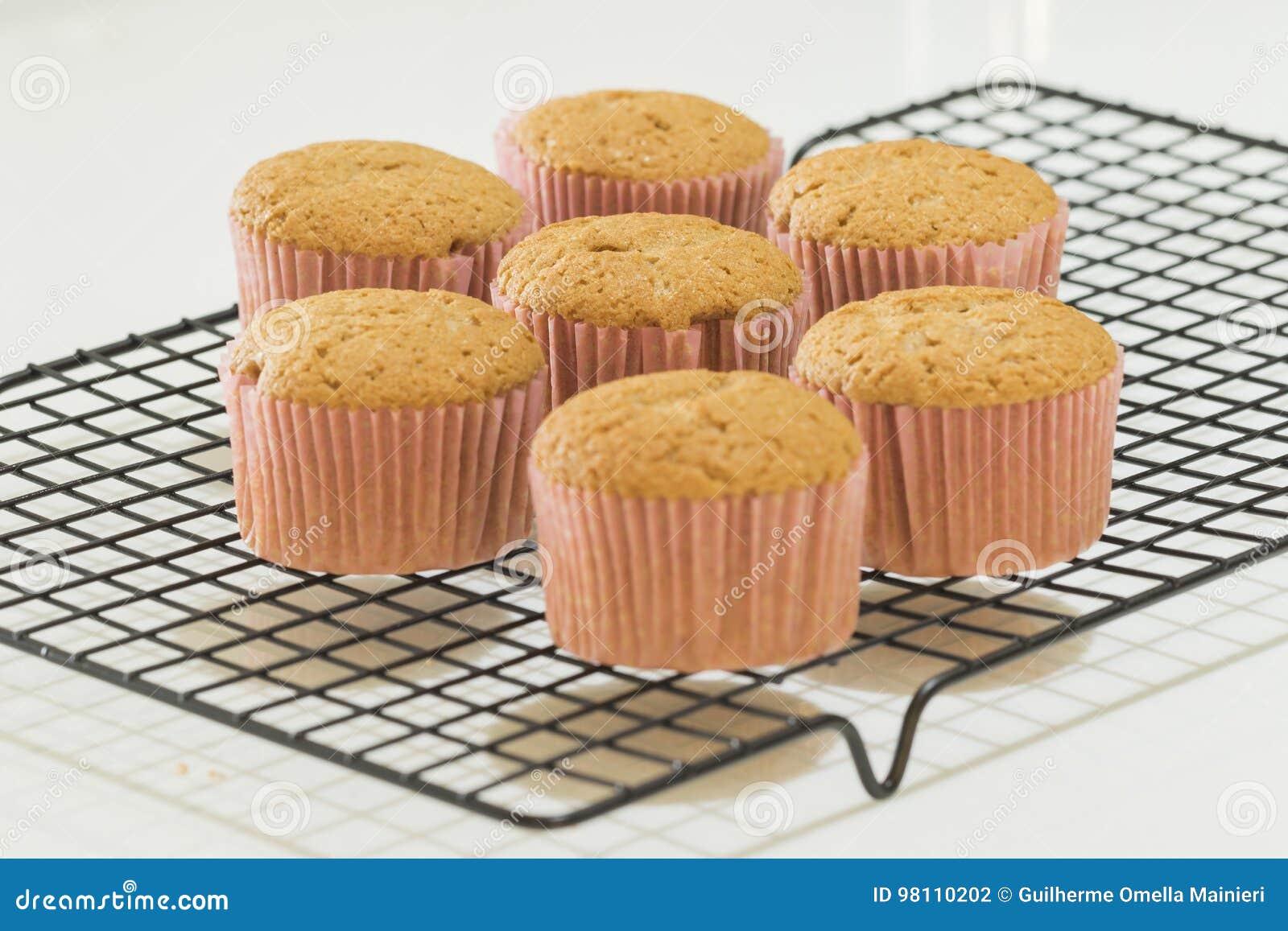 Seven Newly Made Cinnamon Cupcakes in a Cooling Rack Stock Photo ...