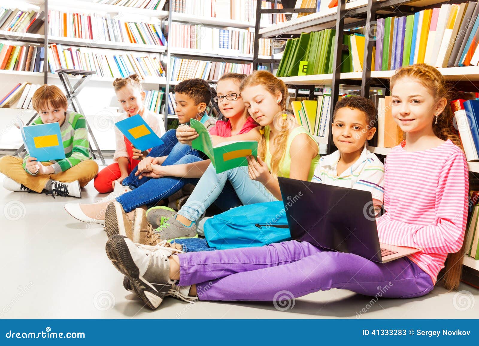 Seven Smiling Children Sitting in a Row on Floor Stock Image - Image of ...