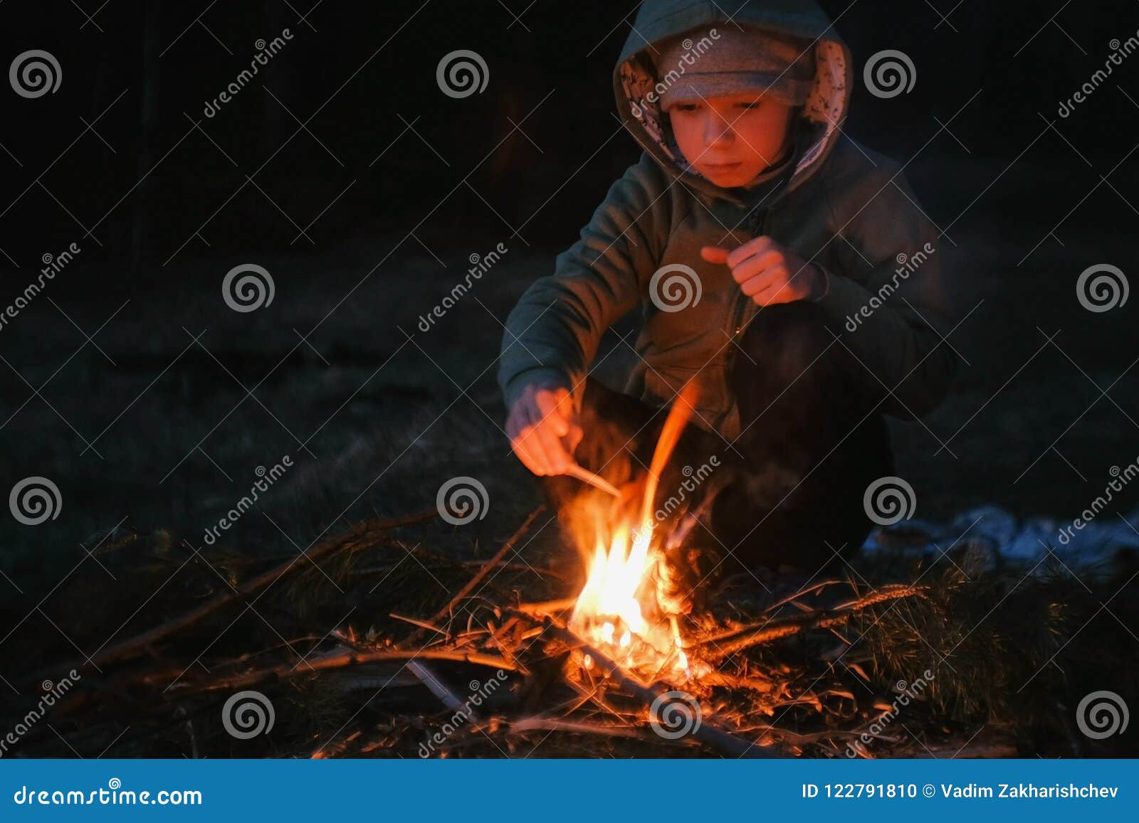 Seven-year-old Boy Light a Fire in the Woods. Stock Photo - Image of ...