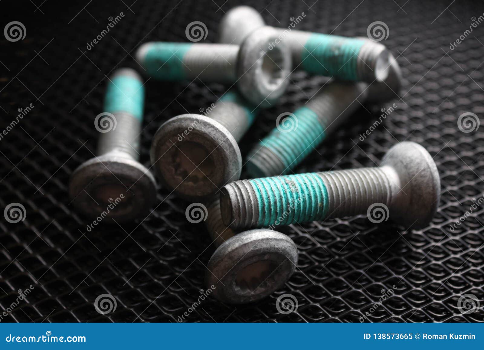 Several Bolts Covered with Blue Thread Lock on Dark Background Stock ...