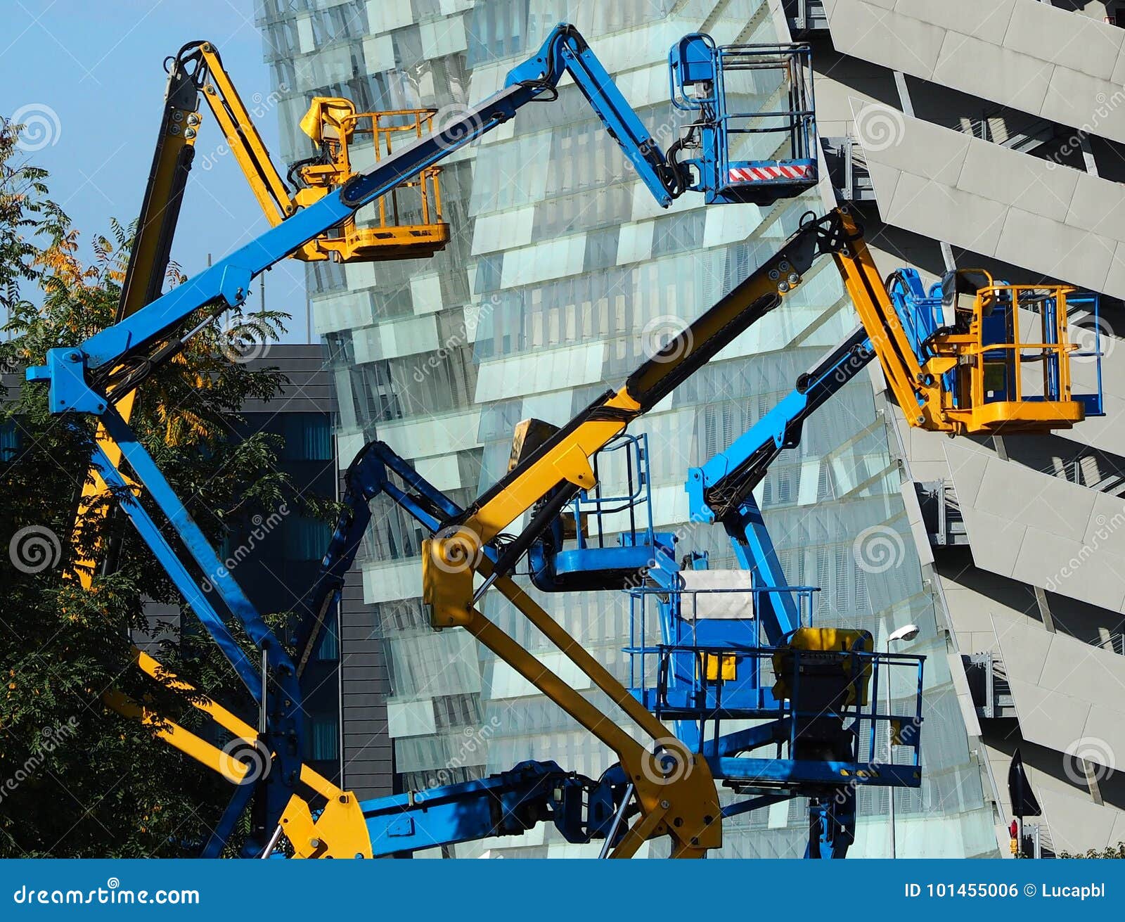 Several Cherry Pickers in Front of a Modern Building Stock Photo ...