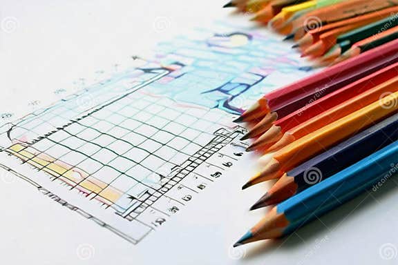 Several Colored Pencils Lie on the Table Next To Sheets of Paper ...