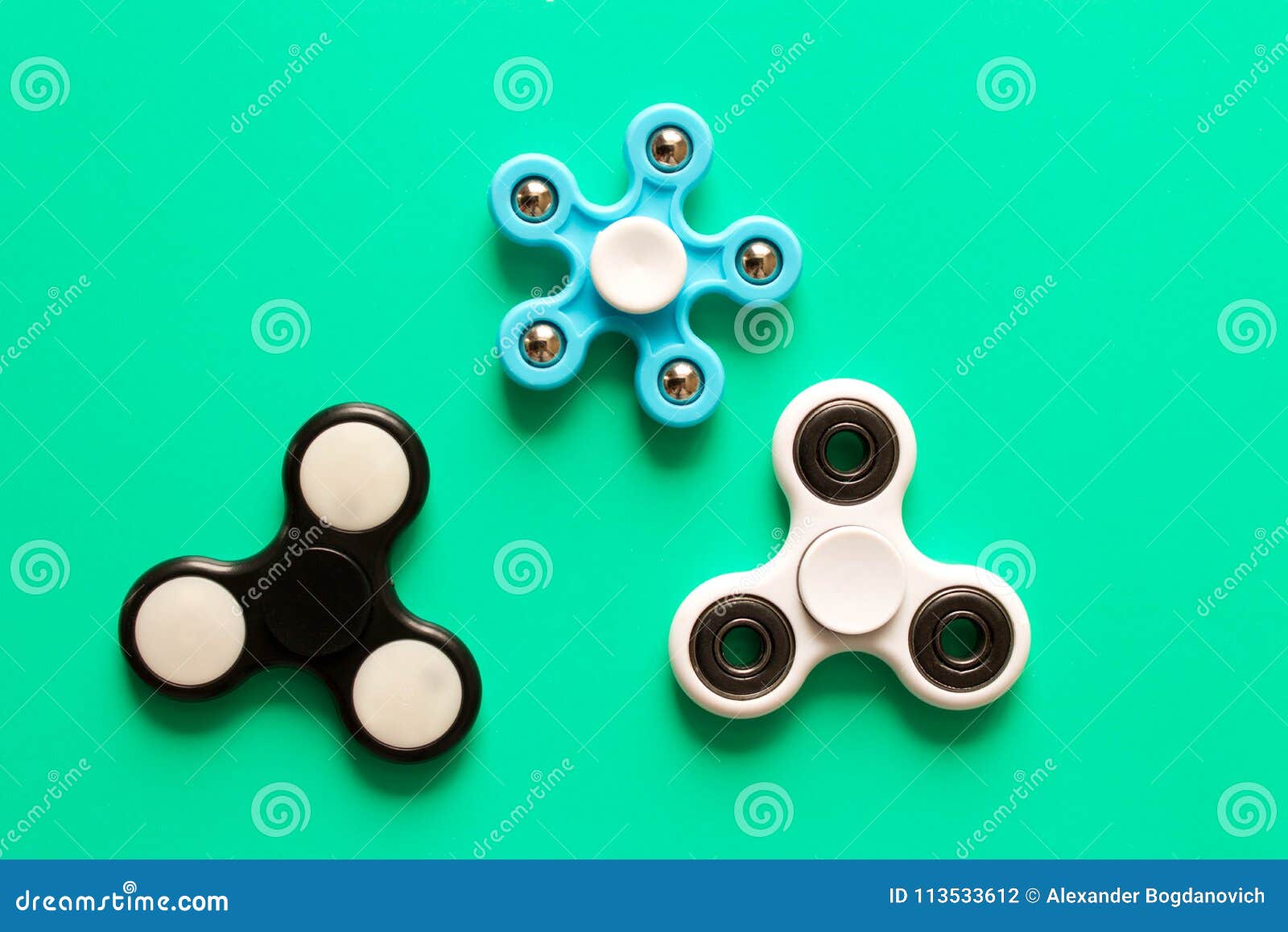 Several Different Fidget Spinners . Isolated on Blue Background Stock ...