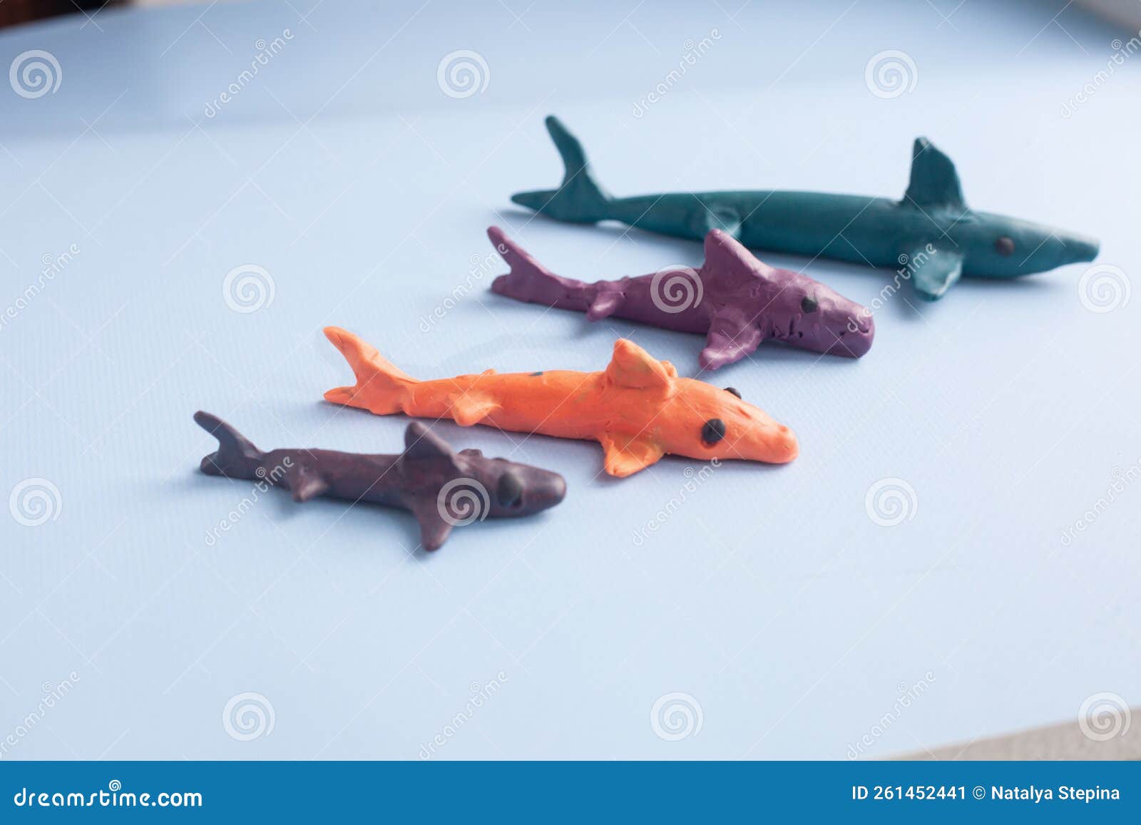 Several Different Sized Pastel Sharks on a Blue Background Stock Image ...
