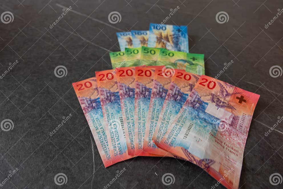 Several Different Swiss Banknotes Nicely Sorted on a Gray Table with ...