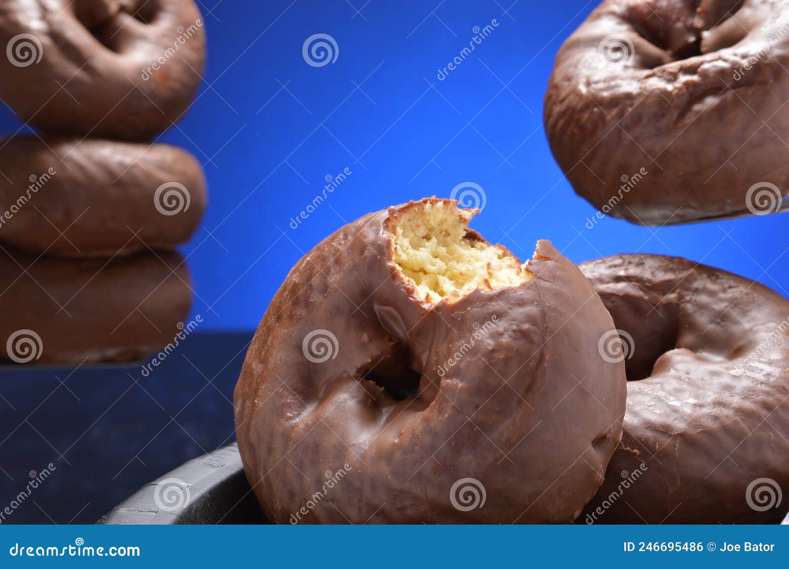 Several Doughnuts with a Bite Taken from One Stock Photo - Image of ...