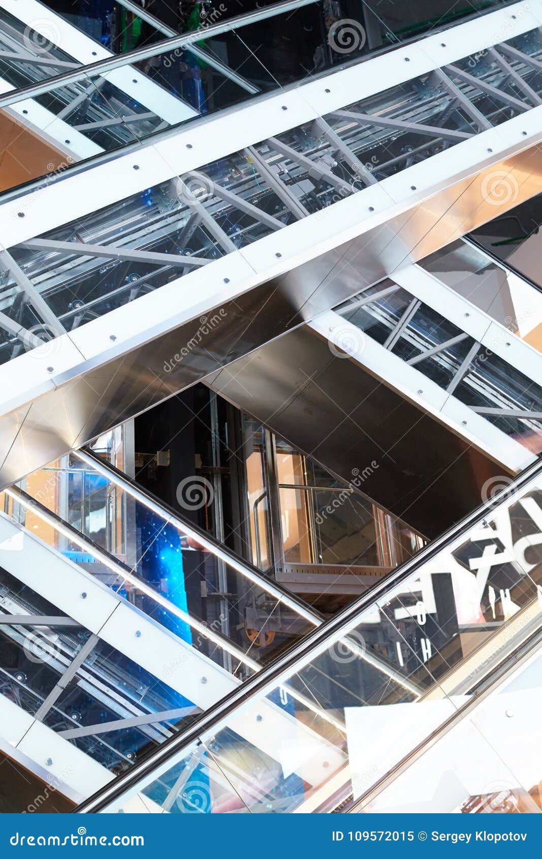 Several Escalators with Transparent Side Panels Intersect in a B Stock ...