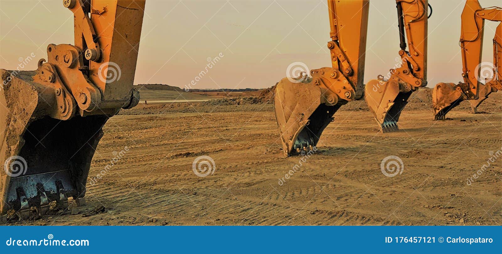 Excavators parked in a row stock image. Image of development - 176457121