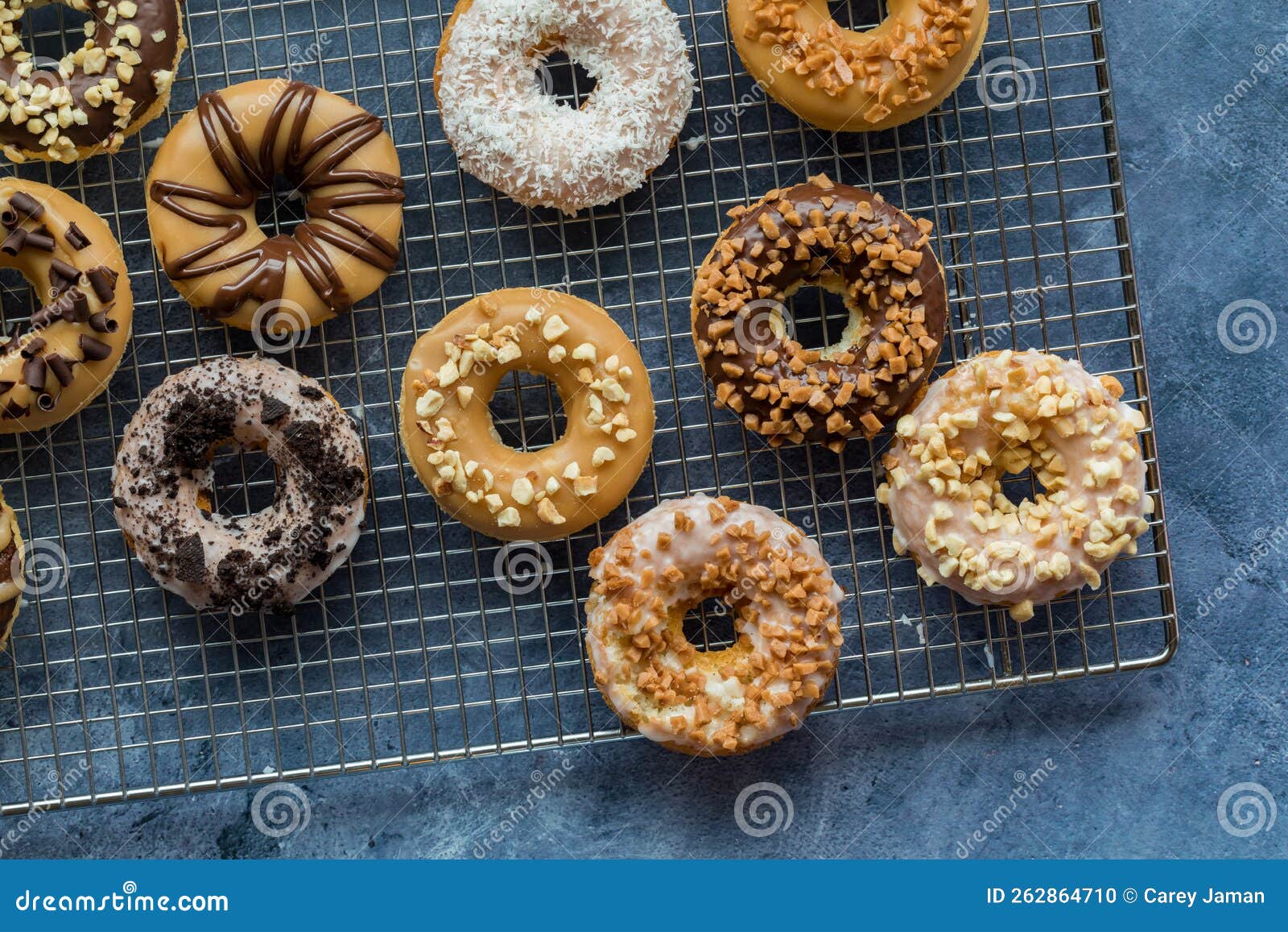 Several Freshly Made Delicious Donuts with Various Toppings, on a ...