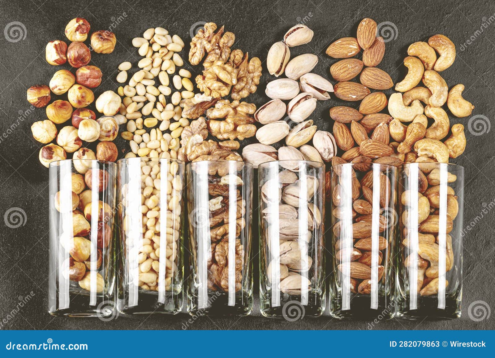 Several Glass Jars with Nuts in Them Sitting on a Counter Stock Image ...